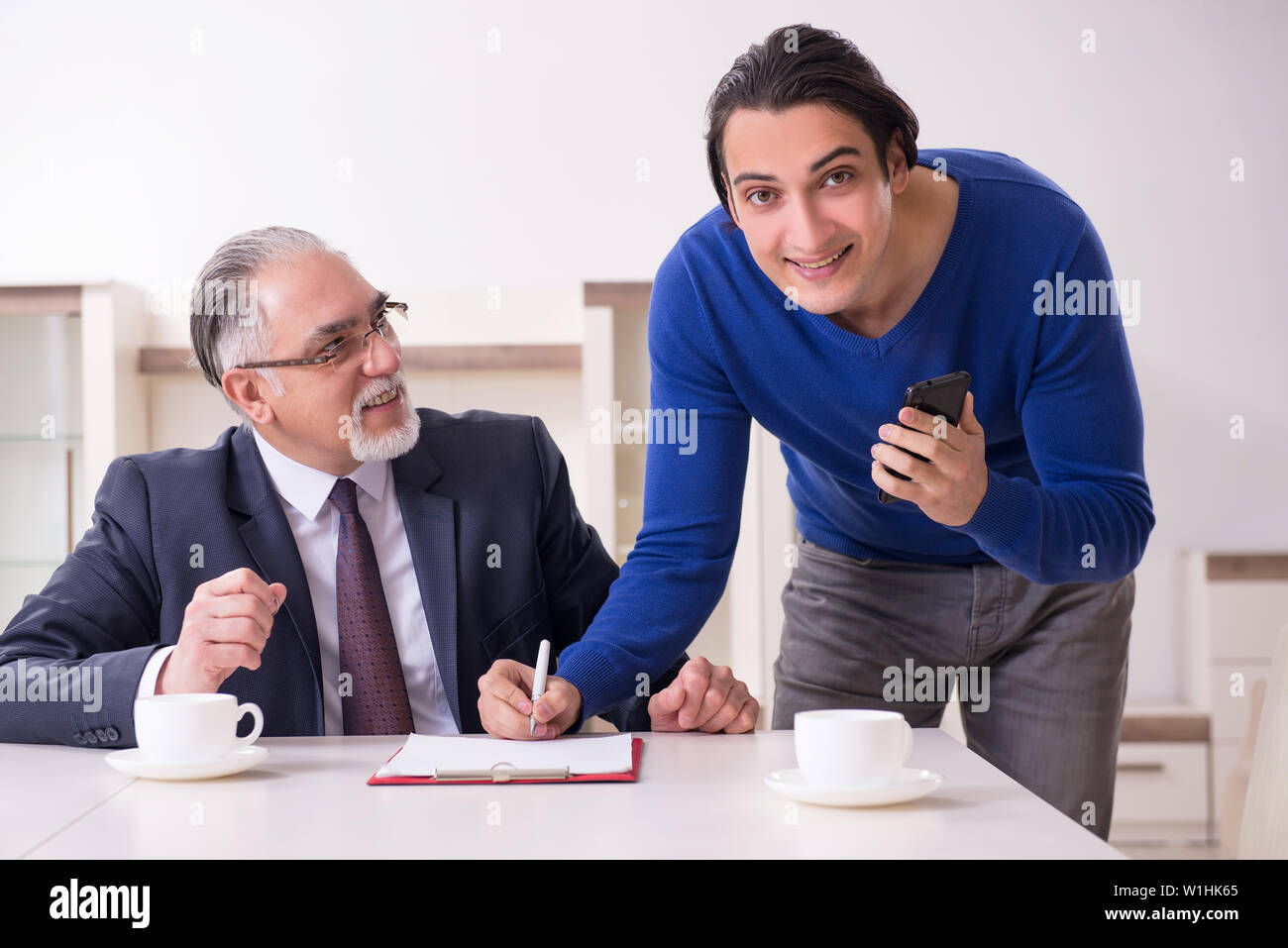 Male real estate agent and male client in the apartment Stock Photo - Alamy