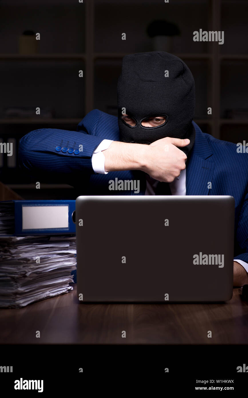 Male employee stealing information in the office night time Stock Photo ...
