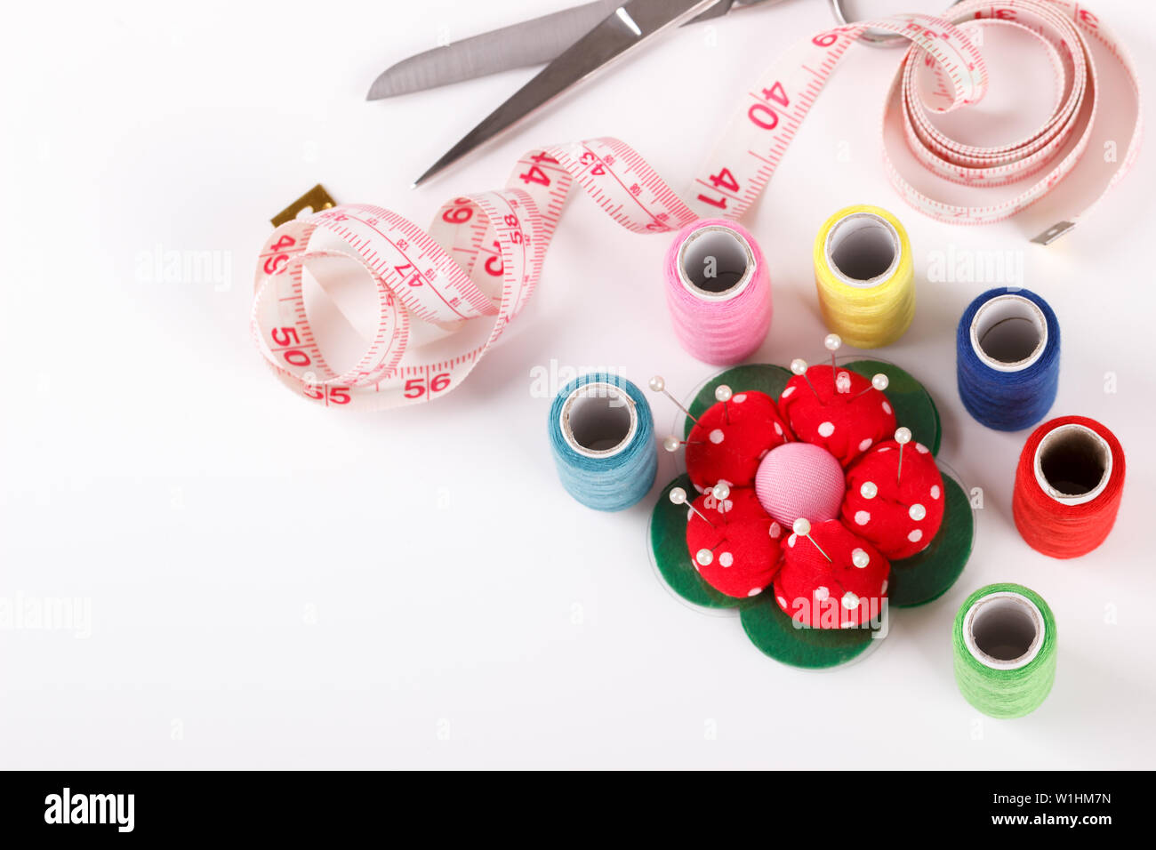 Colorful sewing items on white background, tailor's tools, needles ...