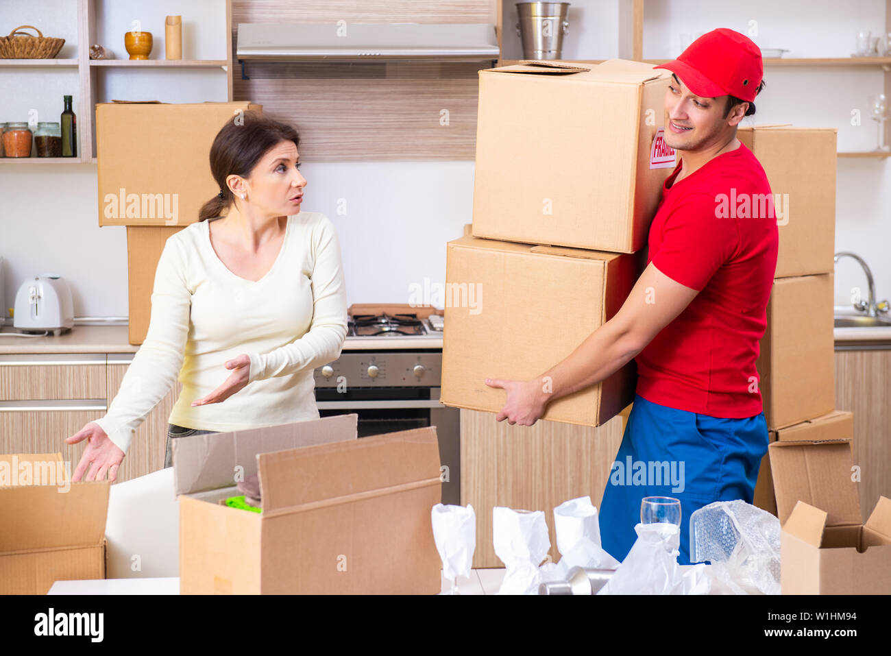 Young male contractor and female customer in moving concept Stock Photo ...