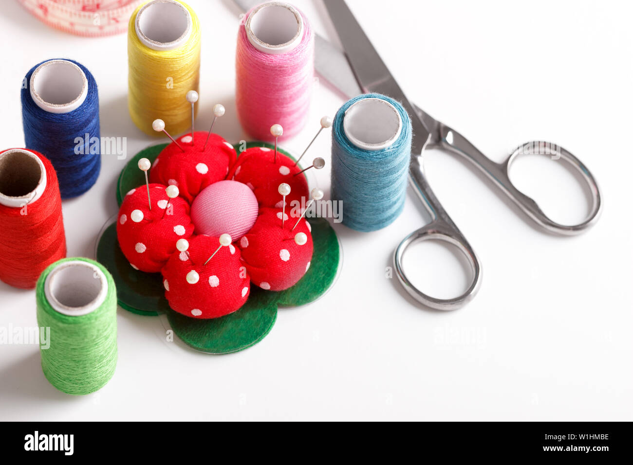 Colorful sewing items on white background, tailor's tools, needles ...