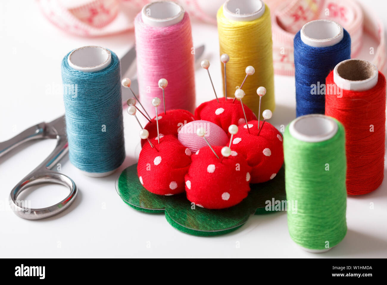 Colorful sewing items on white background, tailor's tools, needles ...