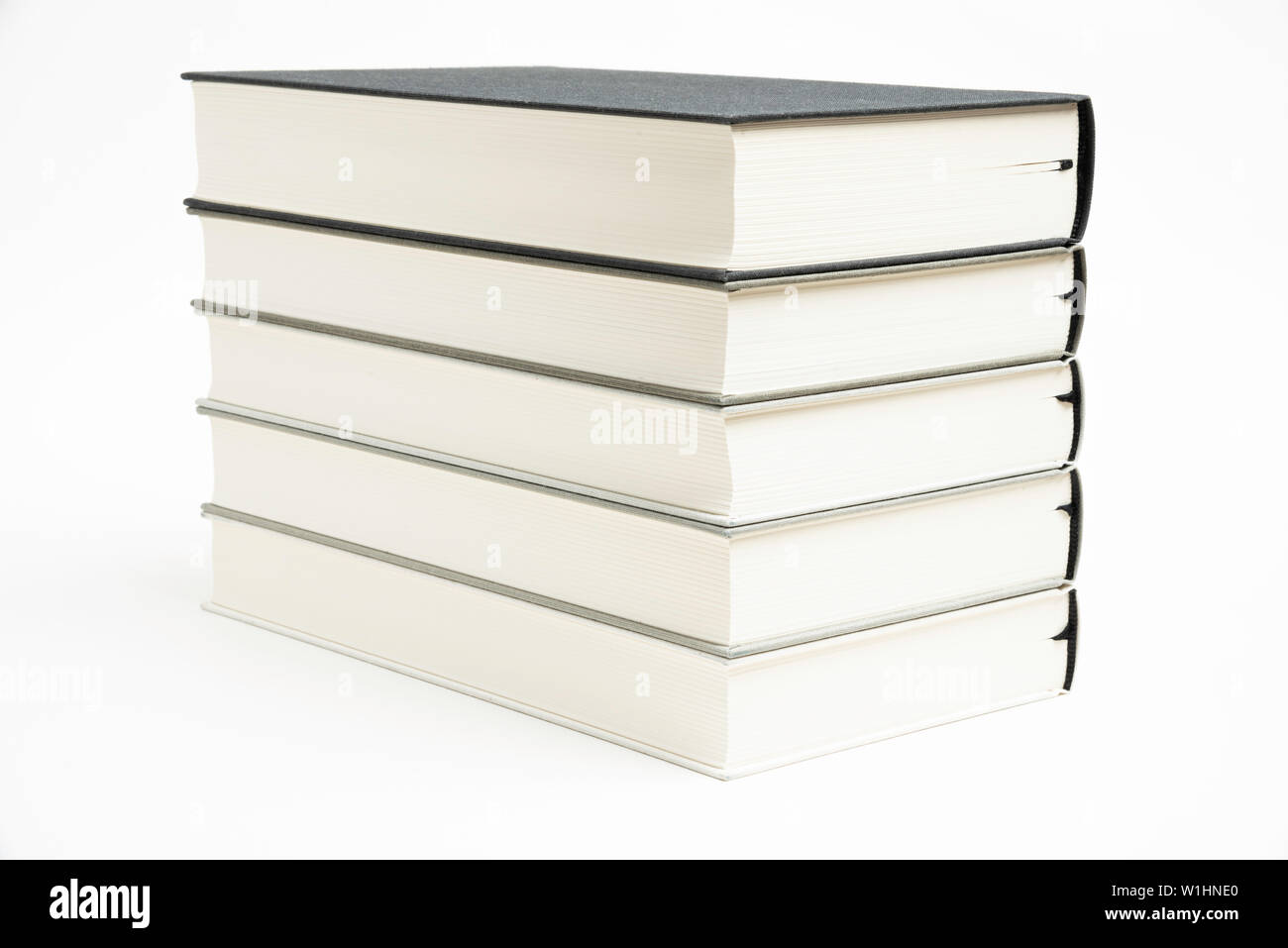 A set of five neatly stacked and arranged monochromatic cloth bound ...