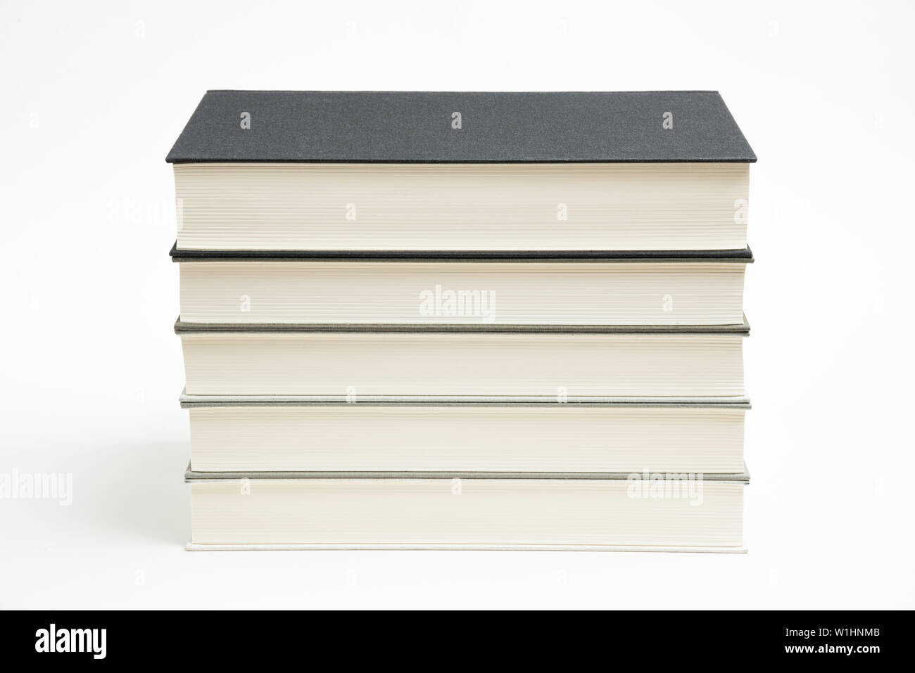 A set of five neatly stacked and arranged monochromatic cloth bound ...
