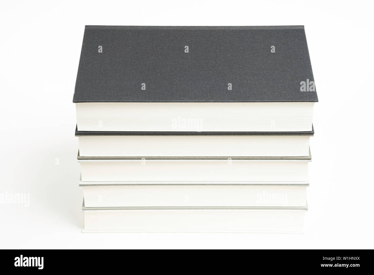 A set of five neatly stacked and arranged monochromatic cloth bound ...