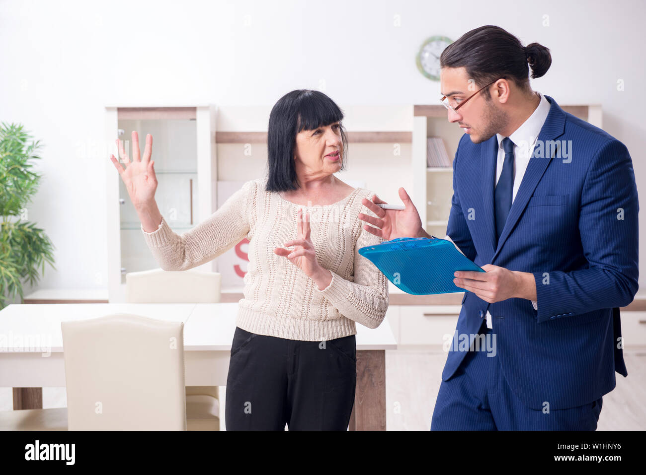 Male real estate agent and female client in the apartment Stock Photo ...