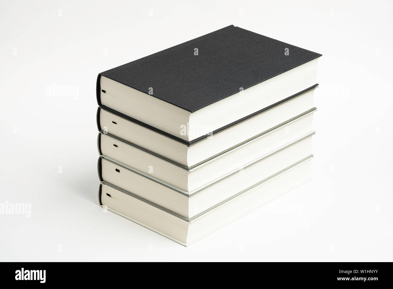 A set of five neatly stacked and arranged monochromatic cloth bound ...