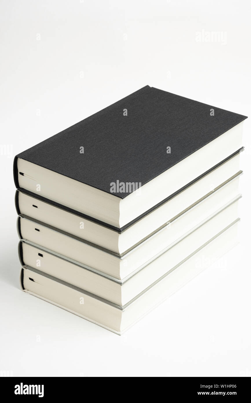 A set of five neatly stacked and arranged monochromatic cloth bound ...