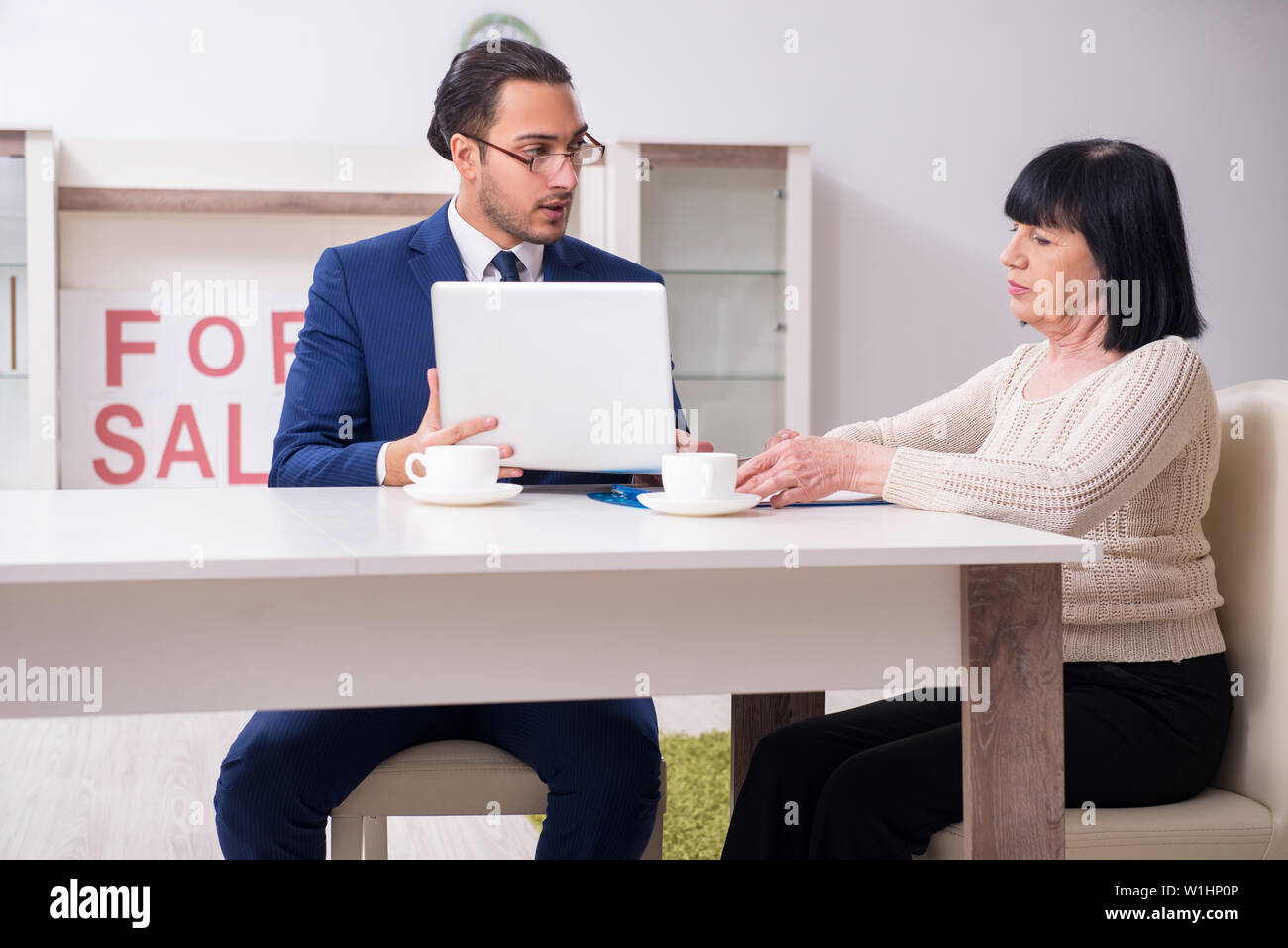 Male real estate agent and female client in the apartment Stock Photo ...