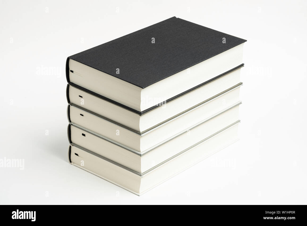 A set of five neatly stacked and arranged monochromatic cloth bound ...