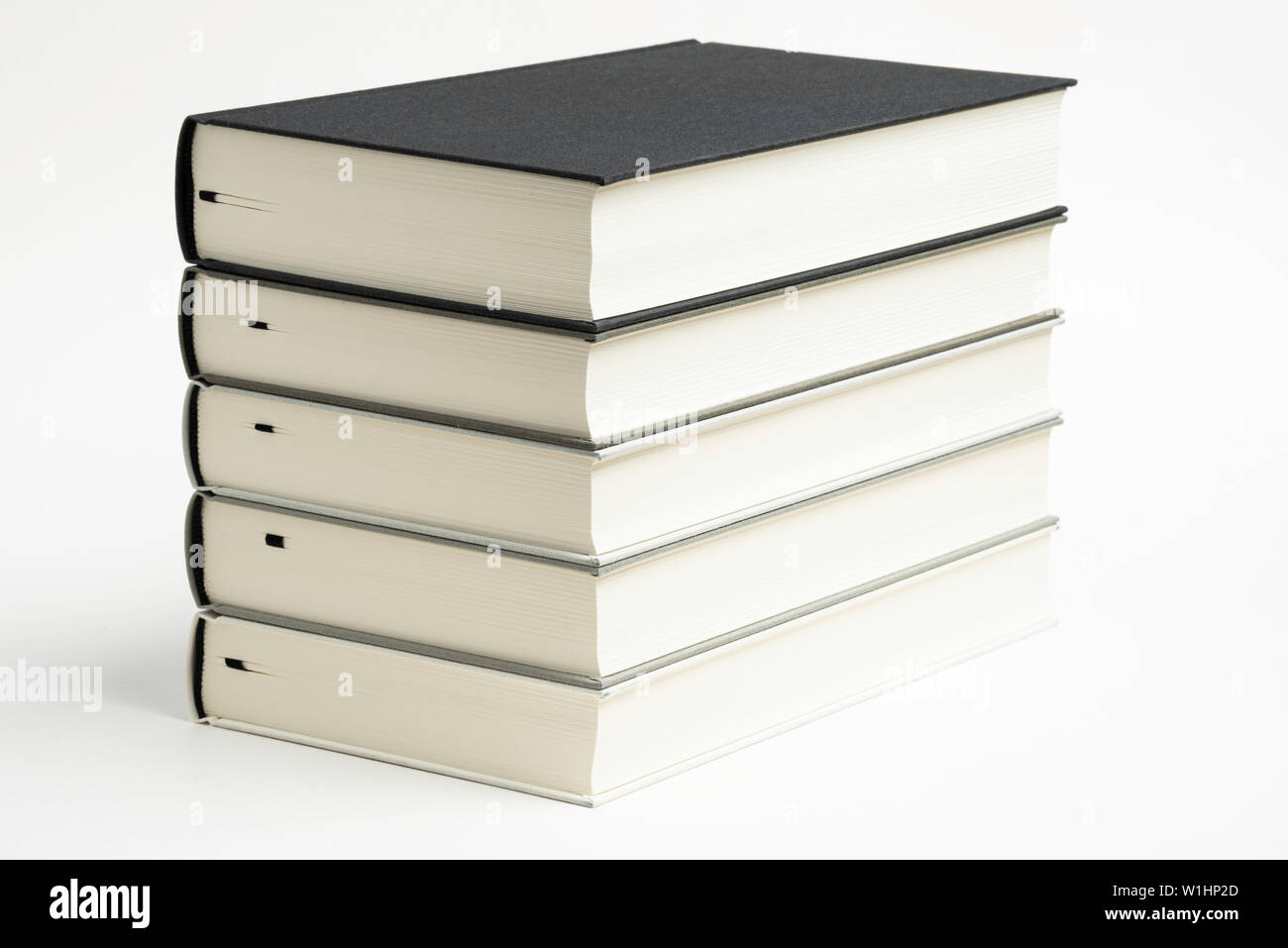 A set of five neatly stacked and arranged monochromatic cloth bound ...