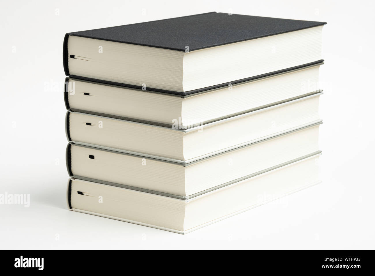 A set of five neatly stacked and arranged monochromatic cloth bound ...