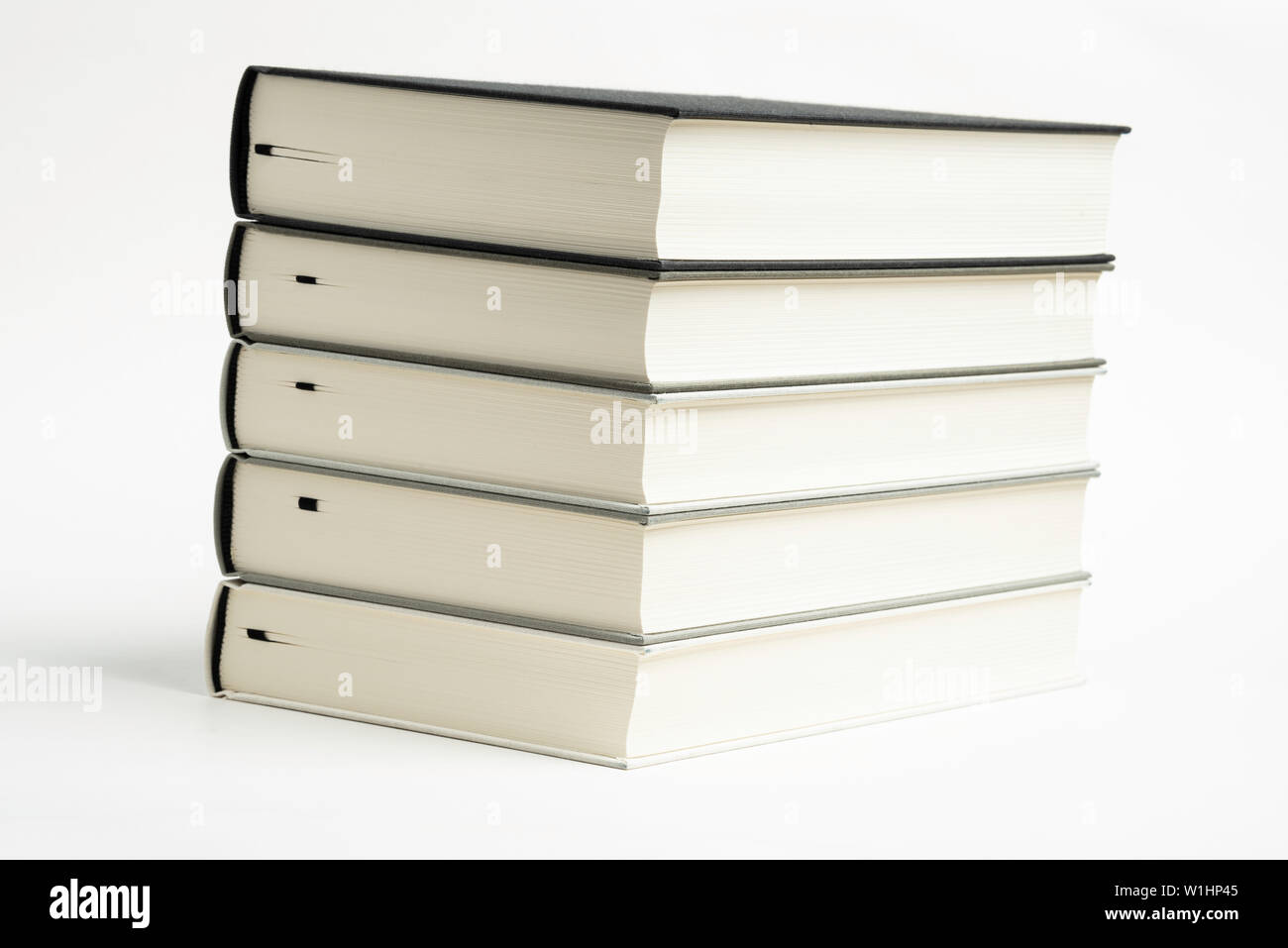 A set of five neatly stacked and arranged monochromatic cloth bound ...