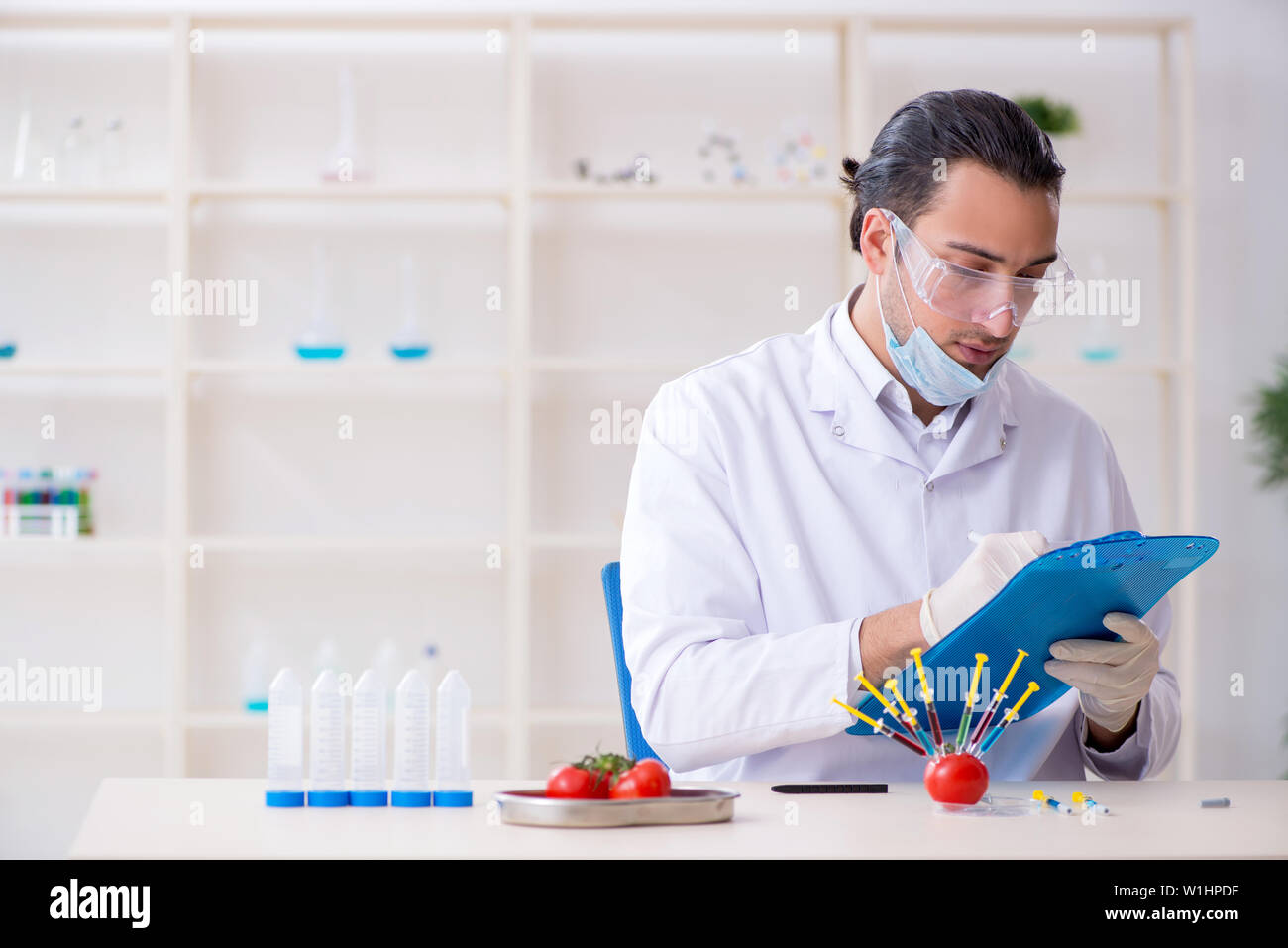 Male nutrition expert testing food products in lab Stock Photo - Alamy