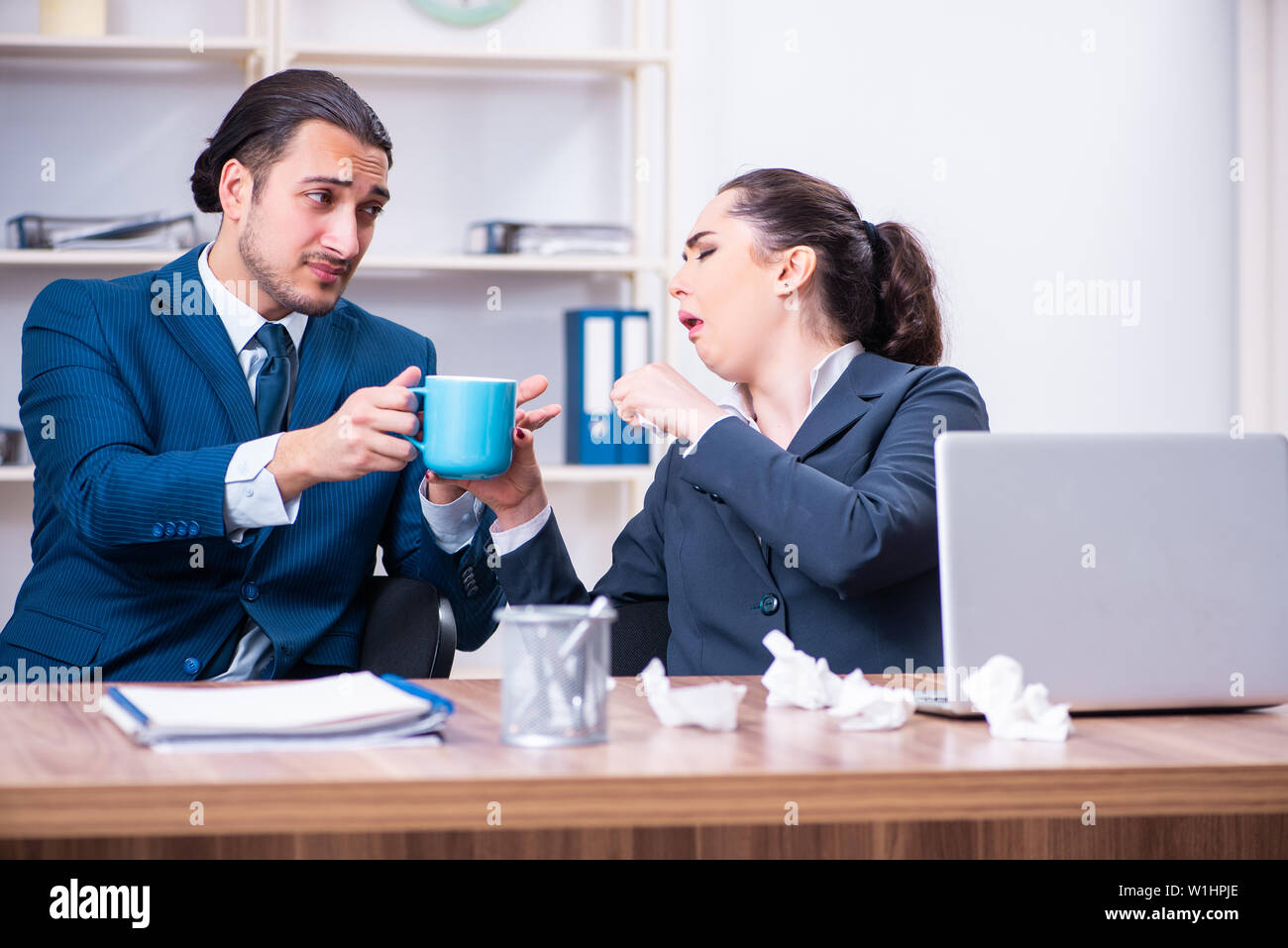 Two employees suffering at workplace Stock Photo - Alamy