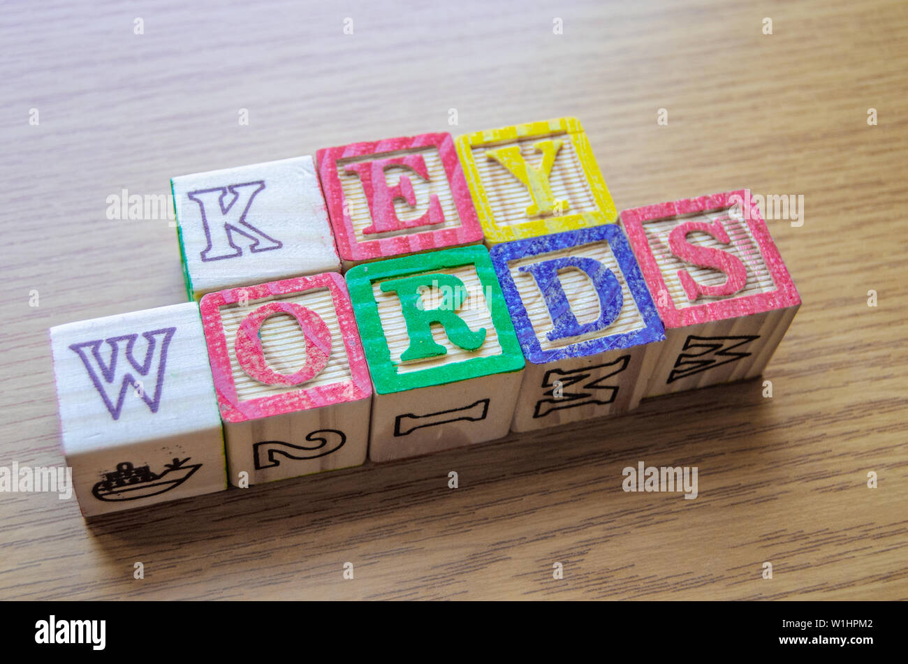 Educational toy cubes with letters organised to display word KEYWORDS ...