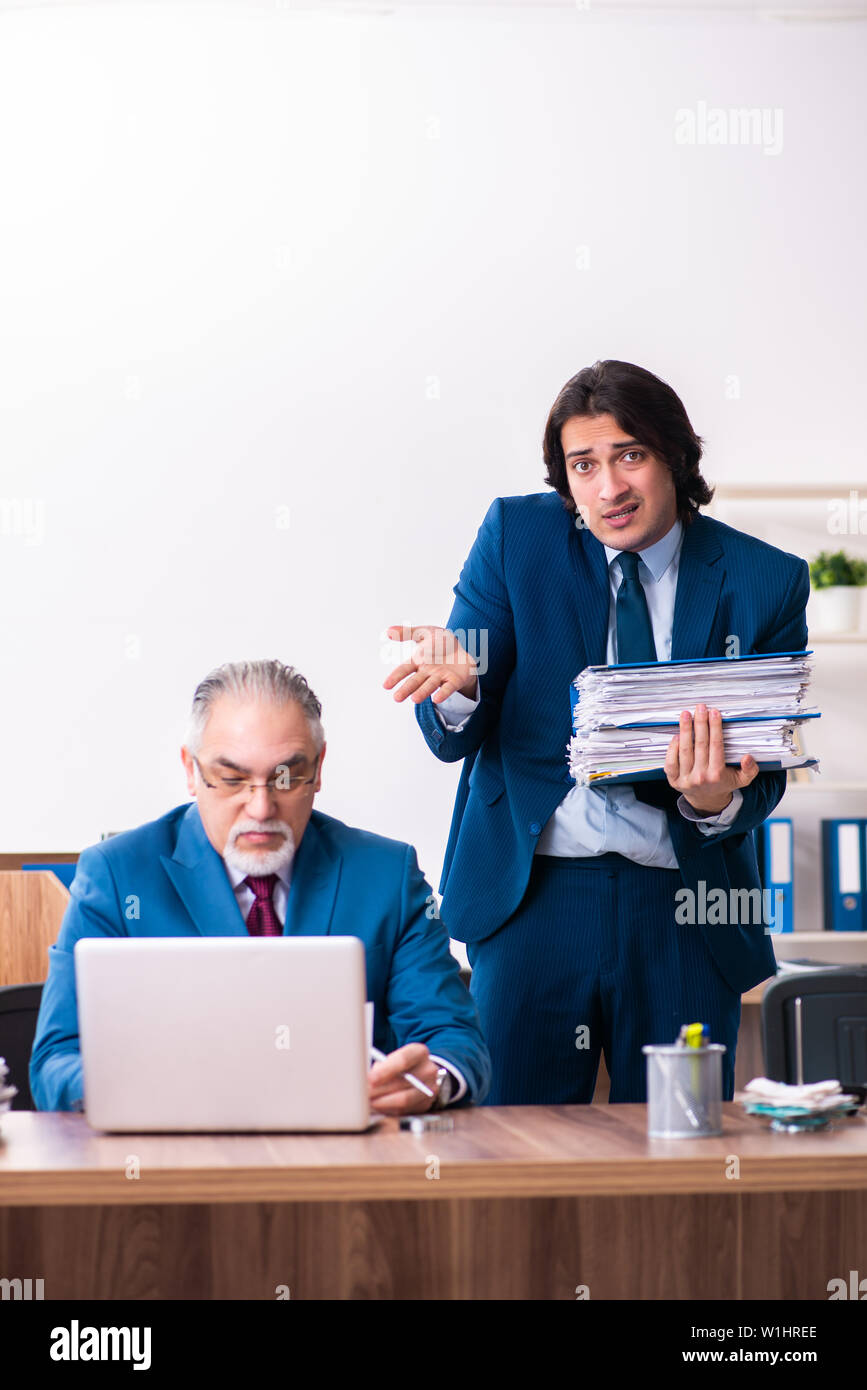 Young and old employees working together in the office Stock Photo - Alamy
