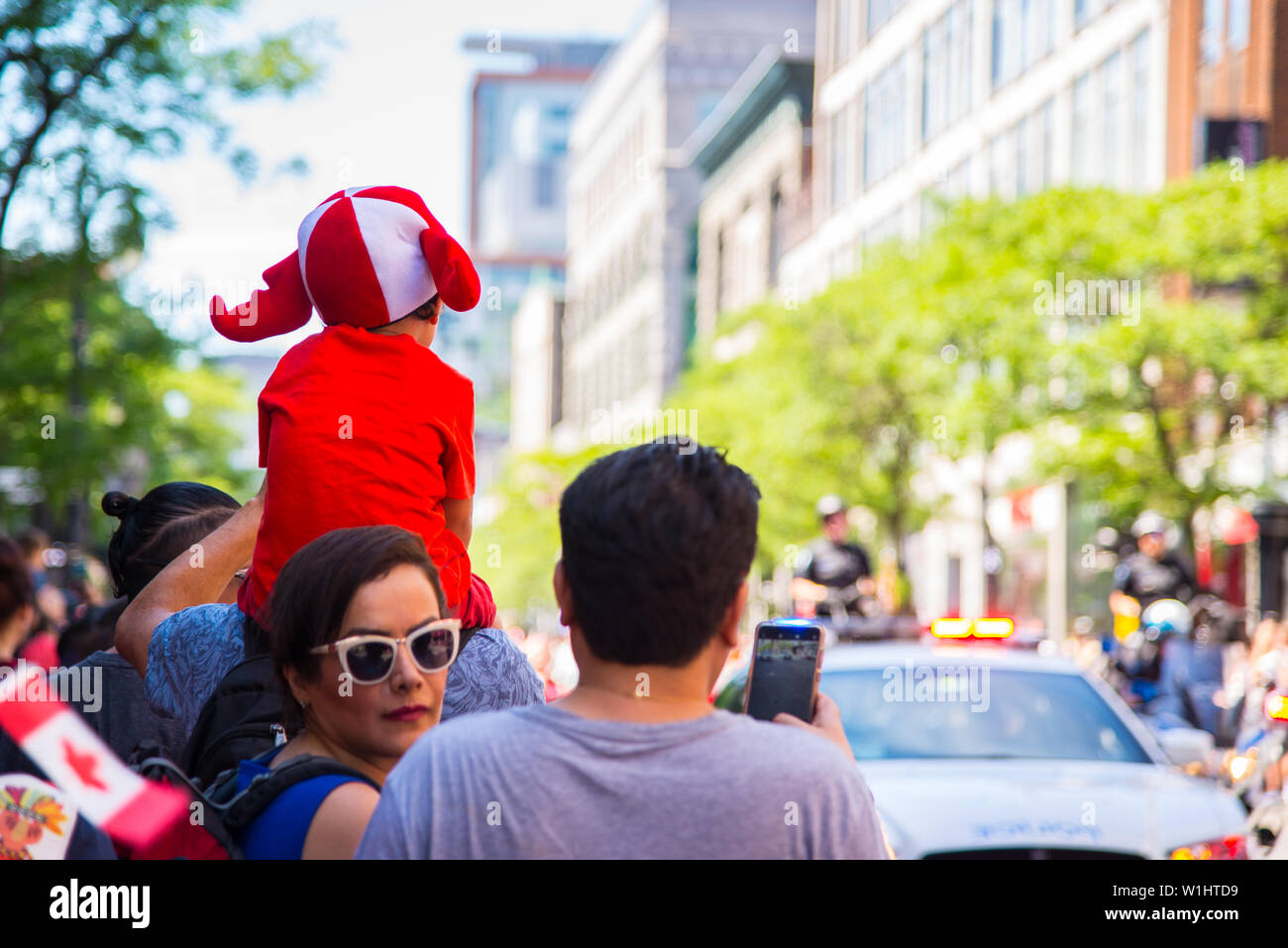 People gathering at downtown Montreal watching the Canada Day Parade ...