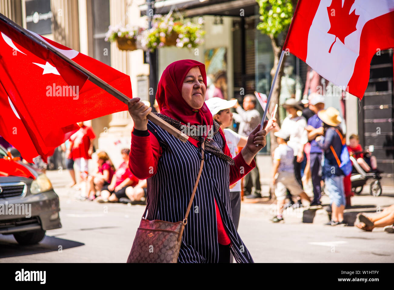 The parade of Canadian National Day in downtown Montreal Stock Photo ...