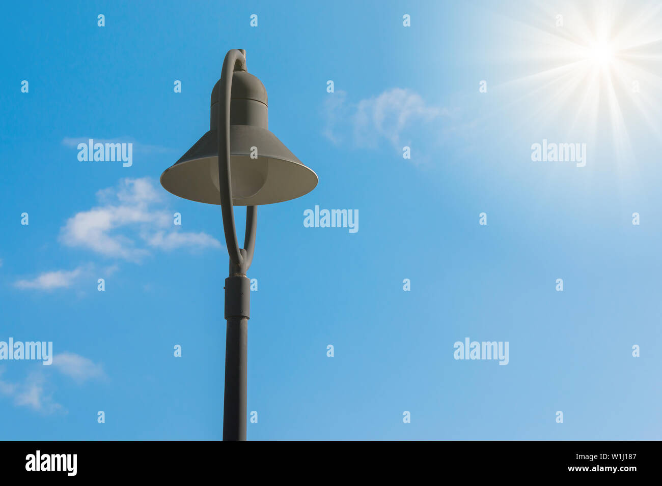 Lamp post in the sky with sun Stock Photo - Alamy