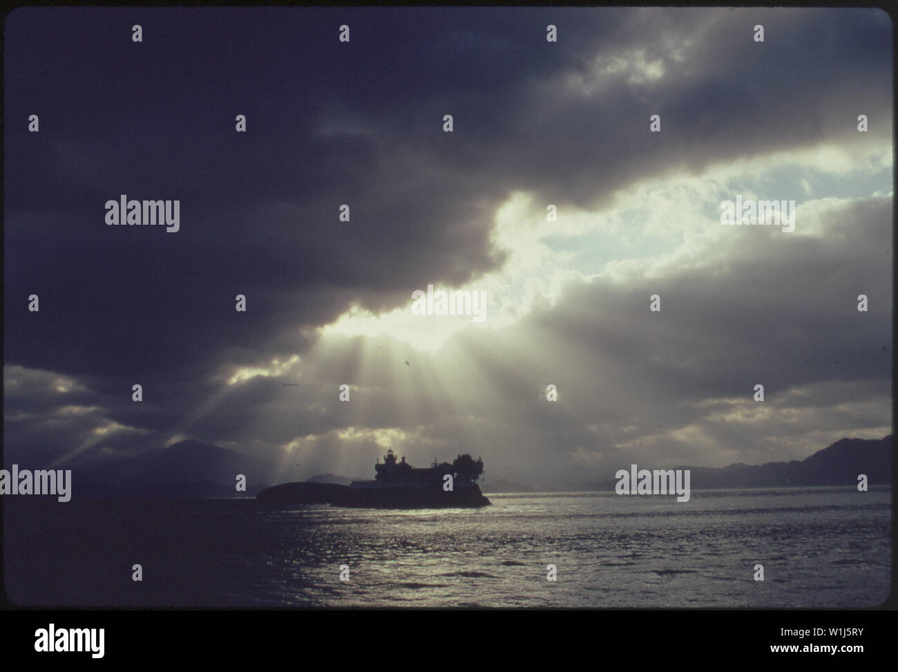 SWORDS OF SUNLIGHT OVER LIGHTHOUSE Stock Photo - Alamy