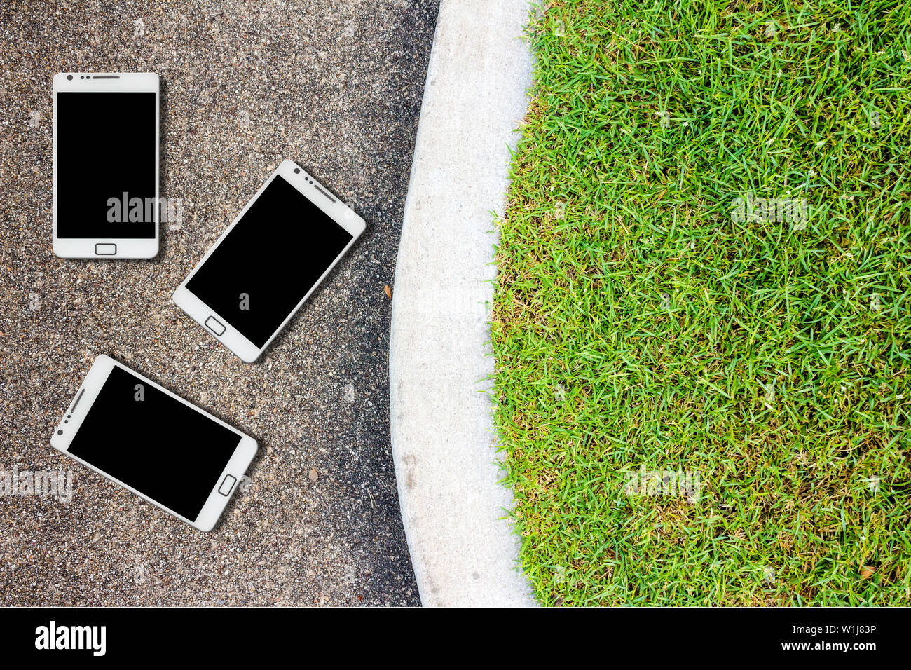 Concrete walkway in the park Have a cell phone on the floor Stock Photo ...