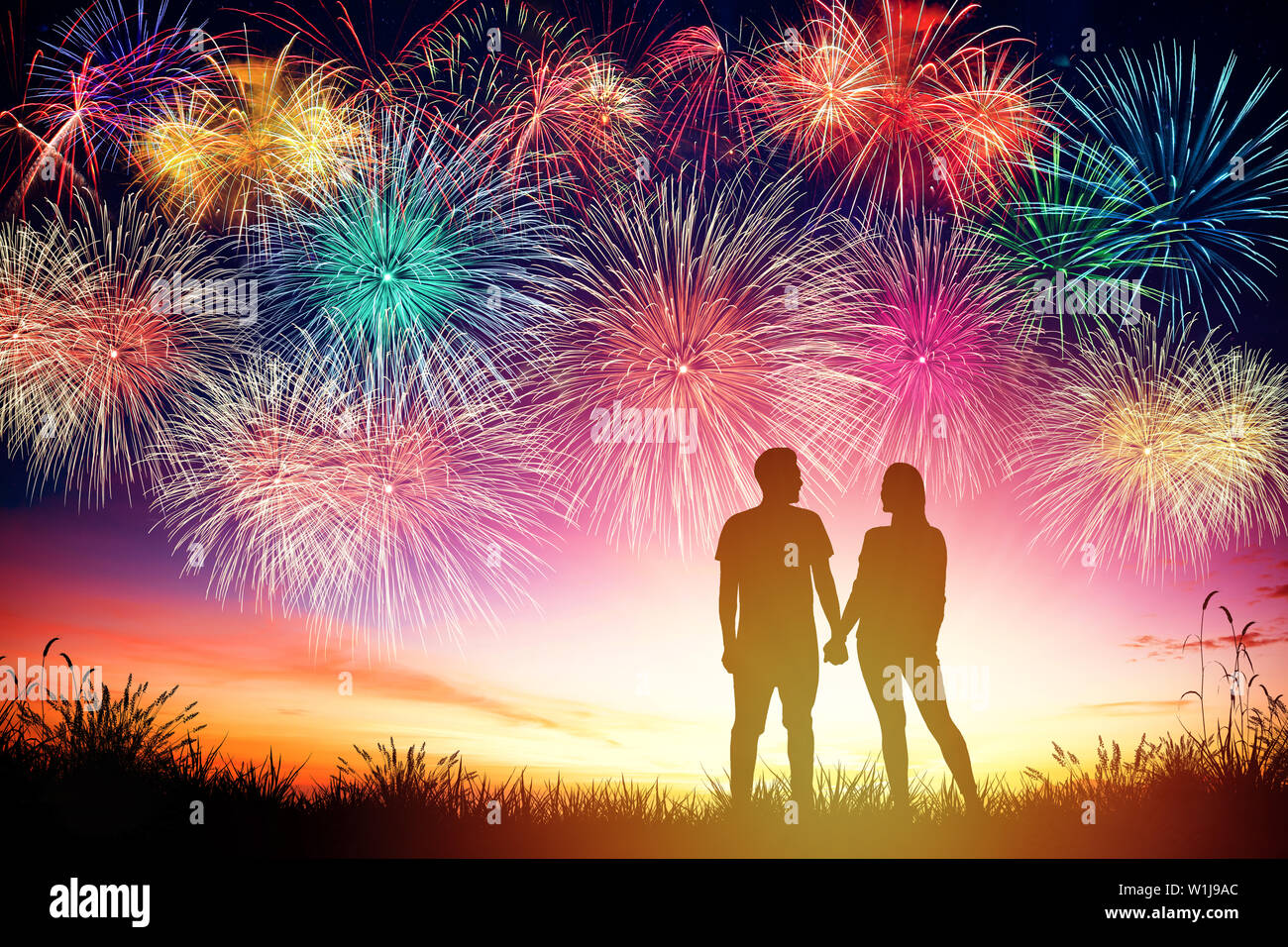 young couple watching fireworks on hill Stock Photo - Alamy