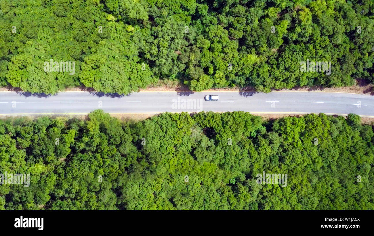 Aerial image of traffic on a mountain forest road Stock Photo - Alamy