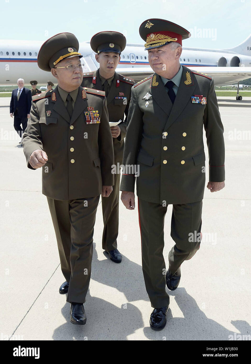 Russian Deputy Defense Minister Alexander Fomin (R) is greeted at ...