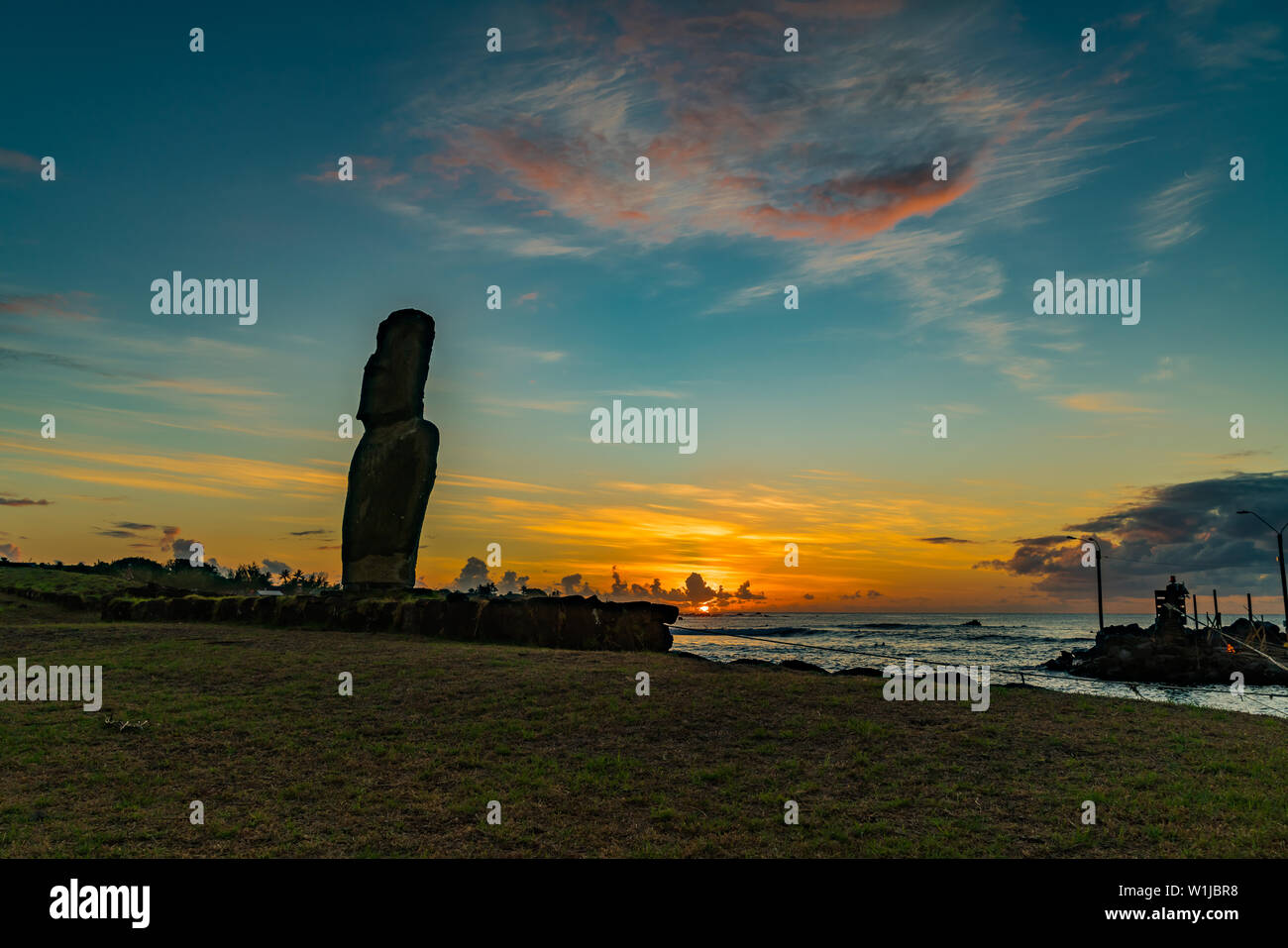 Silhouette of single Moai at Fisherman Port in The Village of Hanga Roa ...