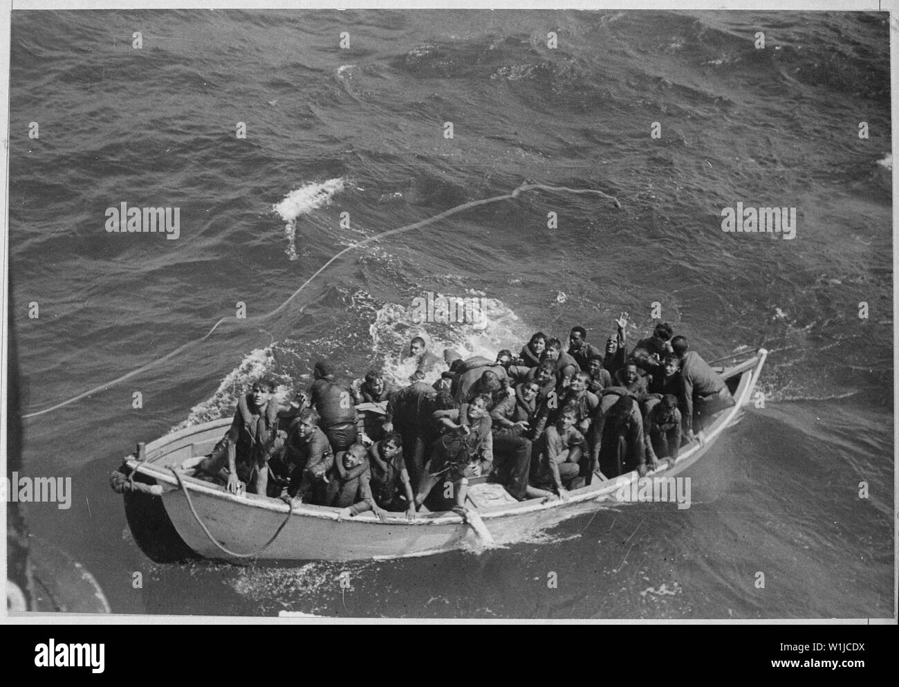 Survivors of USS PRINCETON adrift in life boat at sea as seen from USS ...