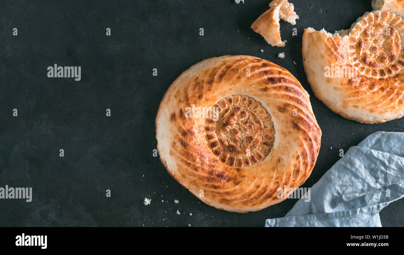 Tasty fresh tandoor bread on black table. Two tandoor flat bread cake ...