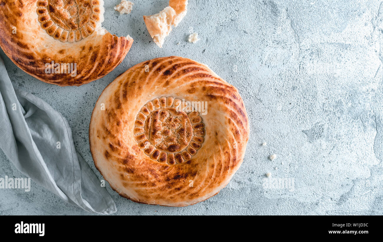 Tasty fresh tandoor bread on gray table. Two tandoor flat bread cake ...