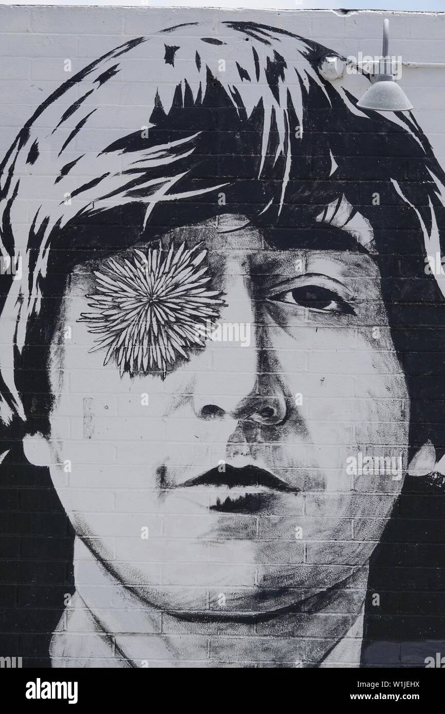 A mural of John Lennon on the side of a wall in Pacific Beach ...