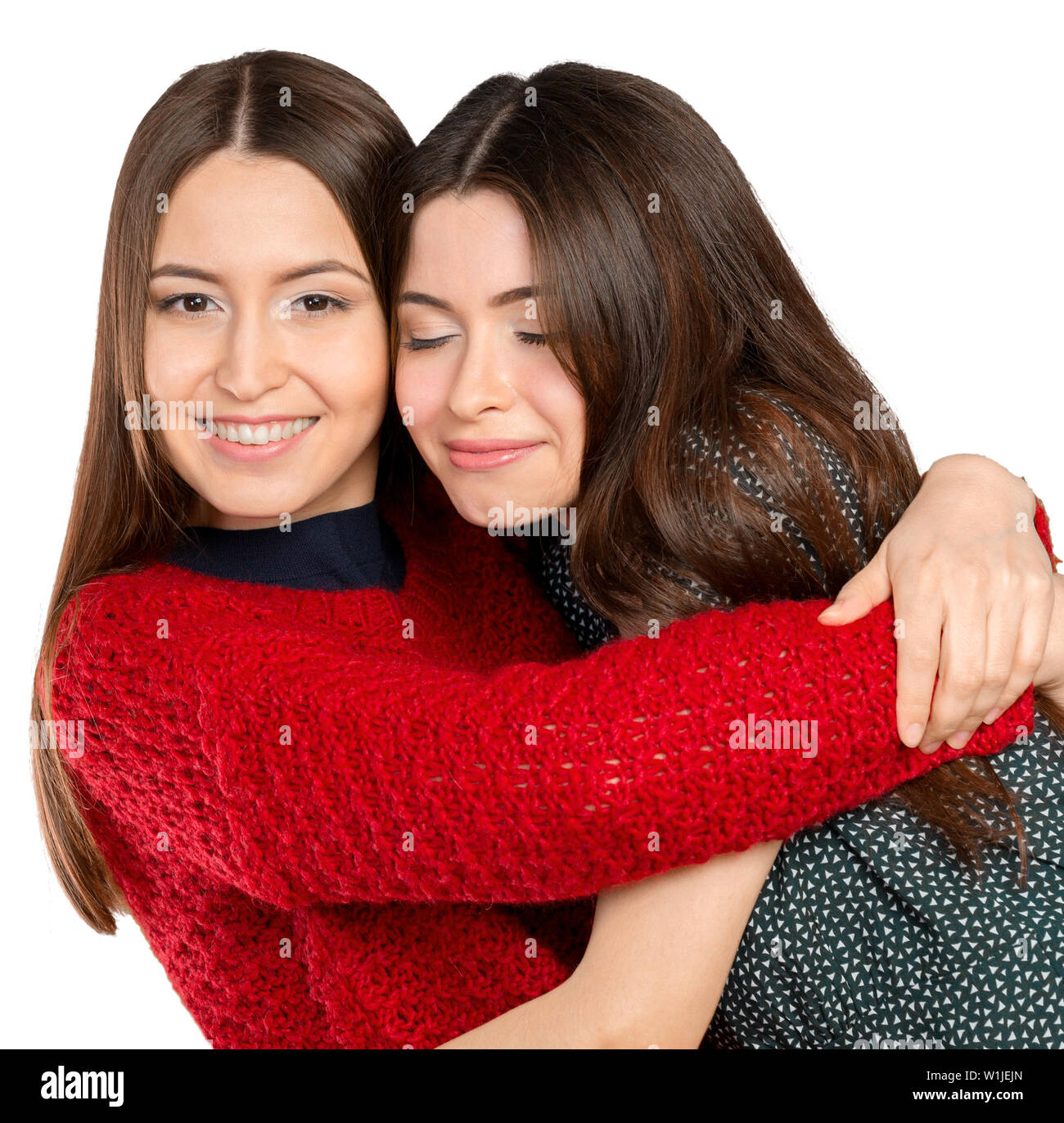 Two beautiful sisters hugging each other and smiling Stock Photo - Alamy