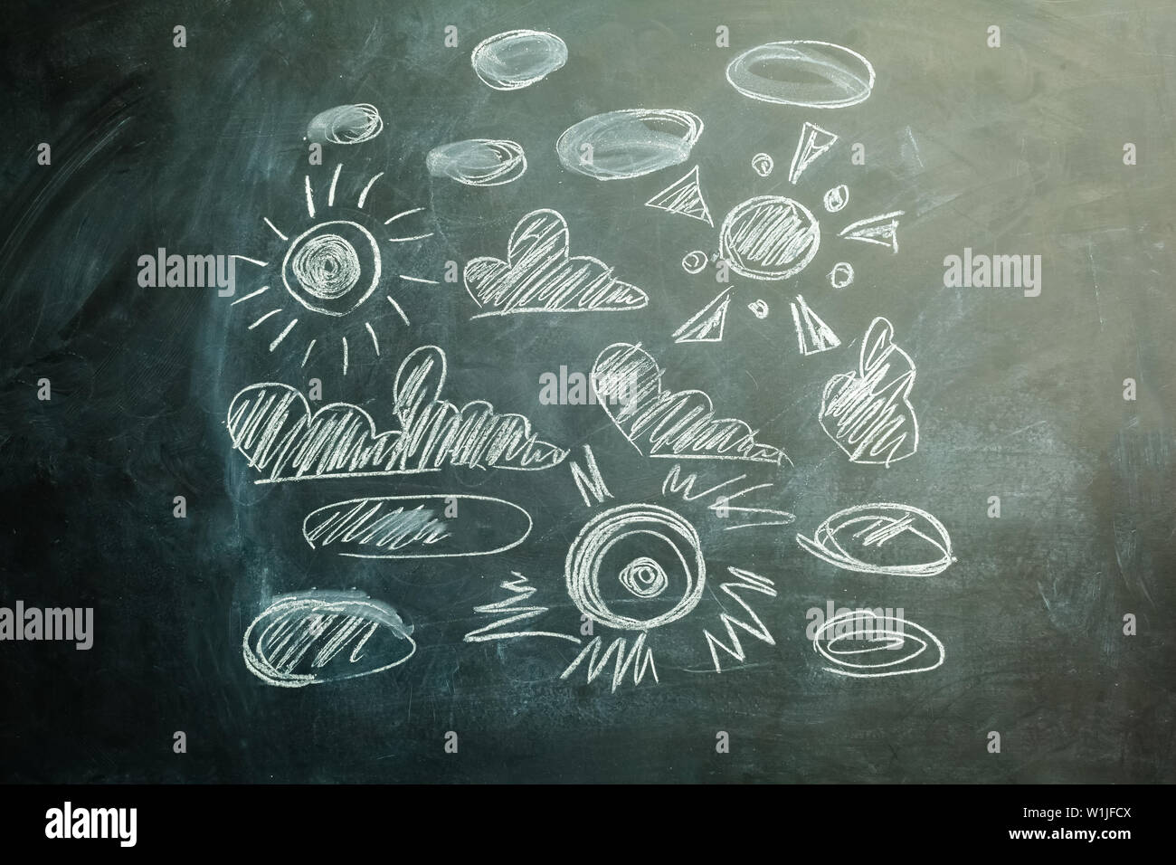 Weather symbols set on on chalkboard Stock Photo - Alamy