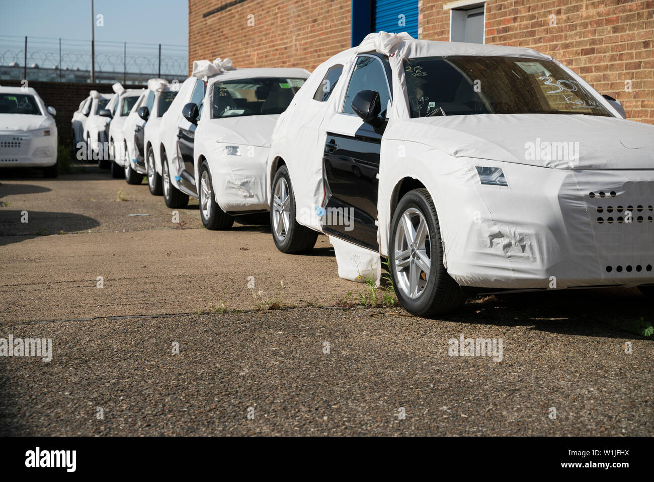 New cars still wrapped Stock Photo - Alamy