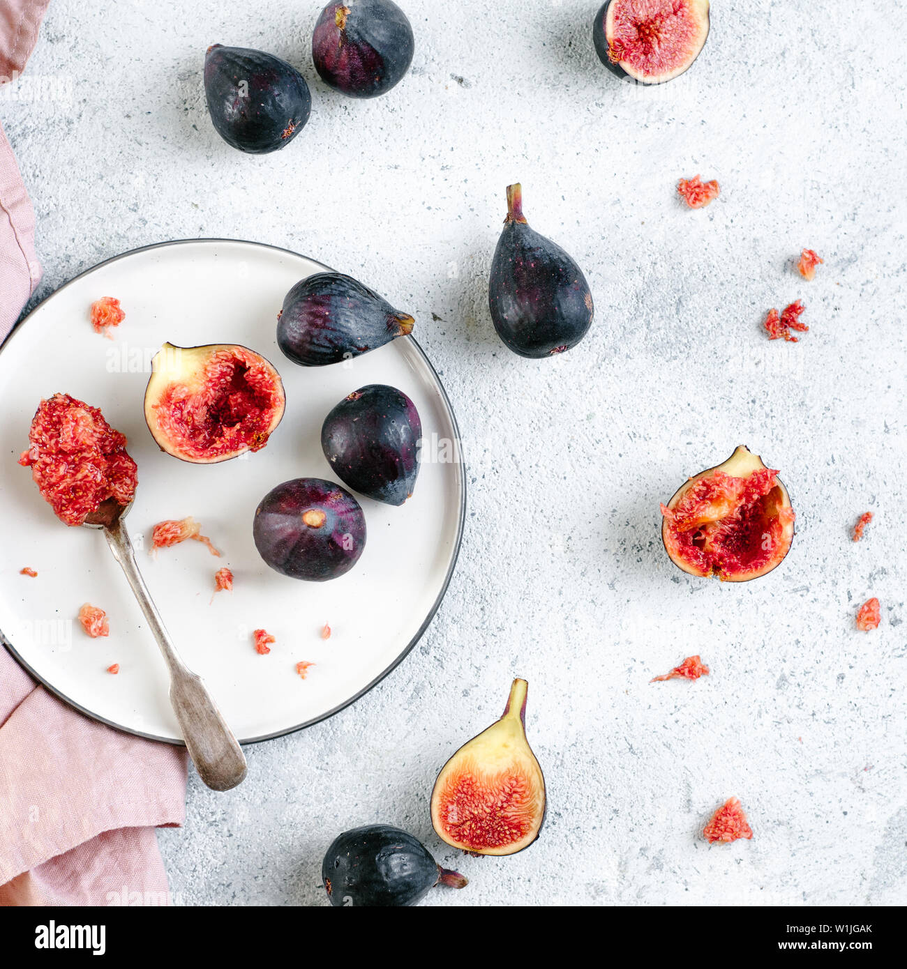 Half and whole figs on gray cement background. Ripe violet figs with ...