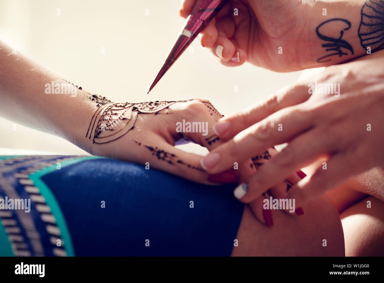 Process of applying mehndi on female hands Stock Photo - Alamy