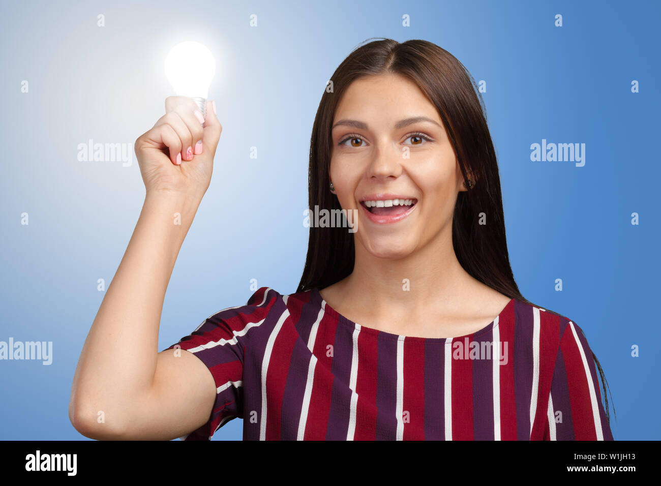 woman pointing at light bulb Stock Photo - Alamy