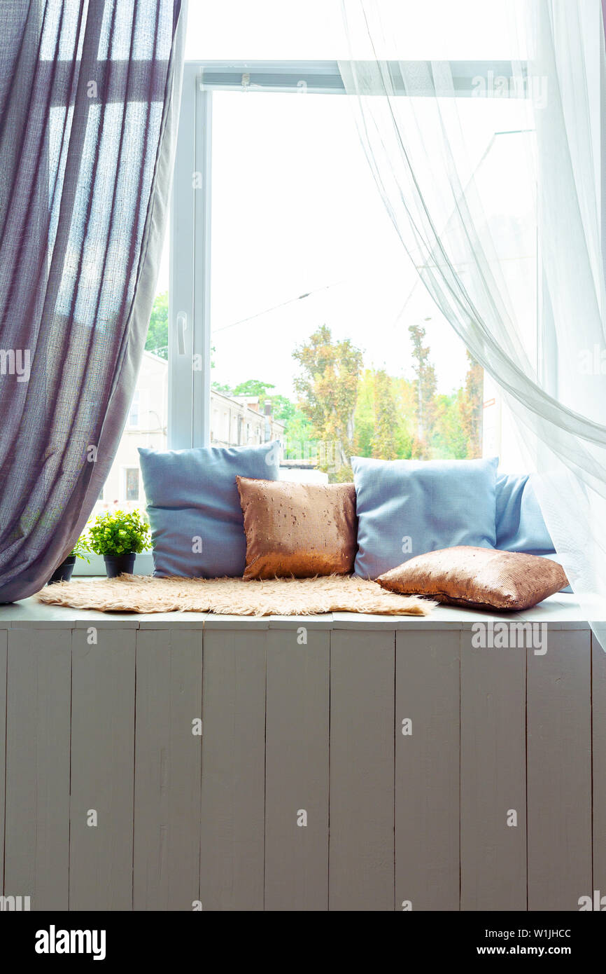 cozy window seat with cushions Stock Photo - Alamy
