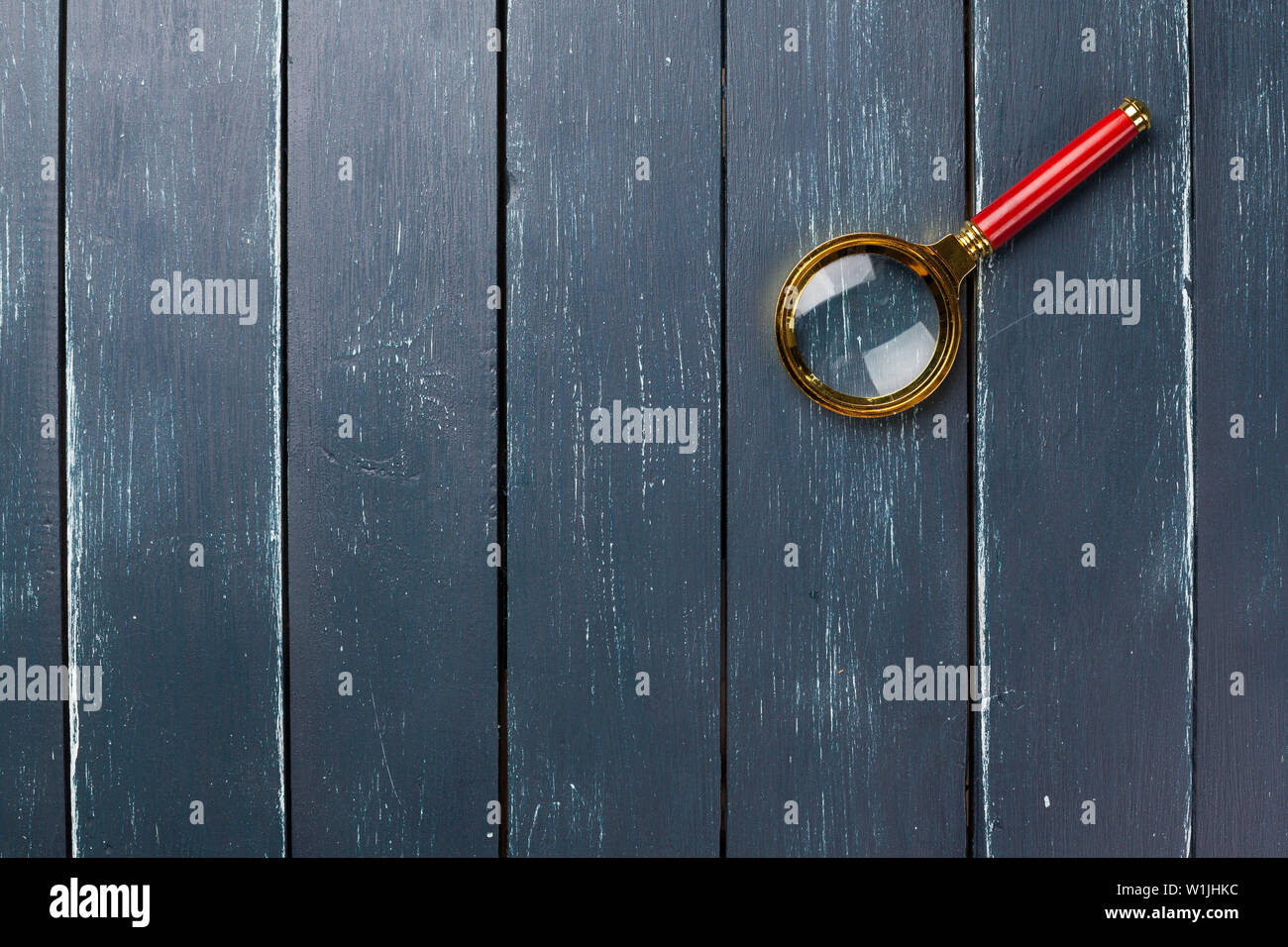 magnifying glass or loupe on wooden table Stock Photo - Alamy