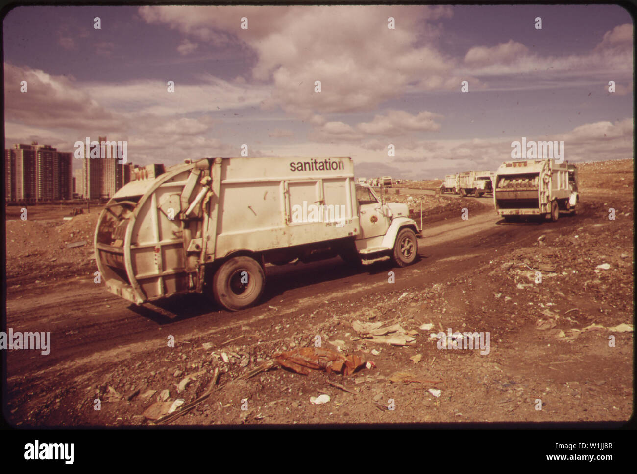 TRUCKS HAUL WASTE MATERIAL TO LANDFILL AREA ADJACENT TO CO-OP CITY, A ...