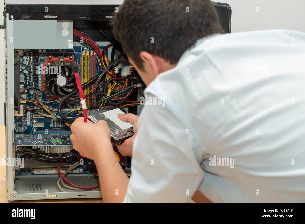 a young man technician repair computer Stock Photo - Alamy