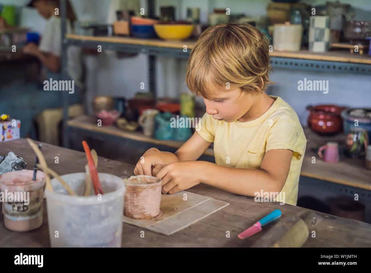 Boy doing ceramic pot in pottery workshop Stock Photo - Alamy