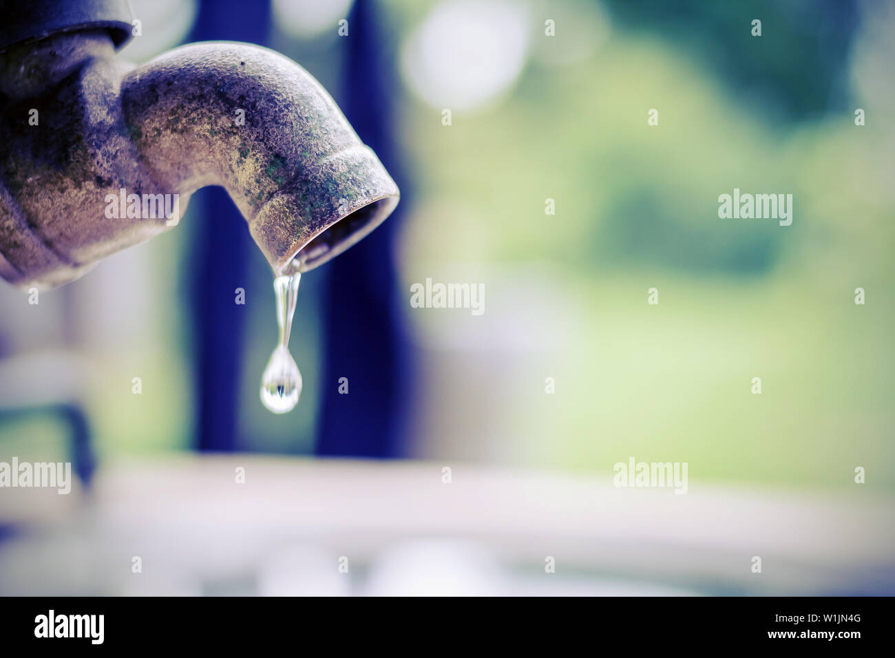 old rusty tap leaking water vintage style Stock Photo - Alamy