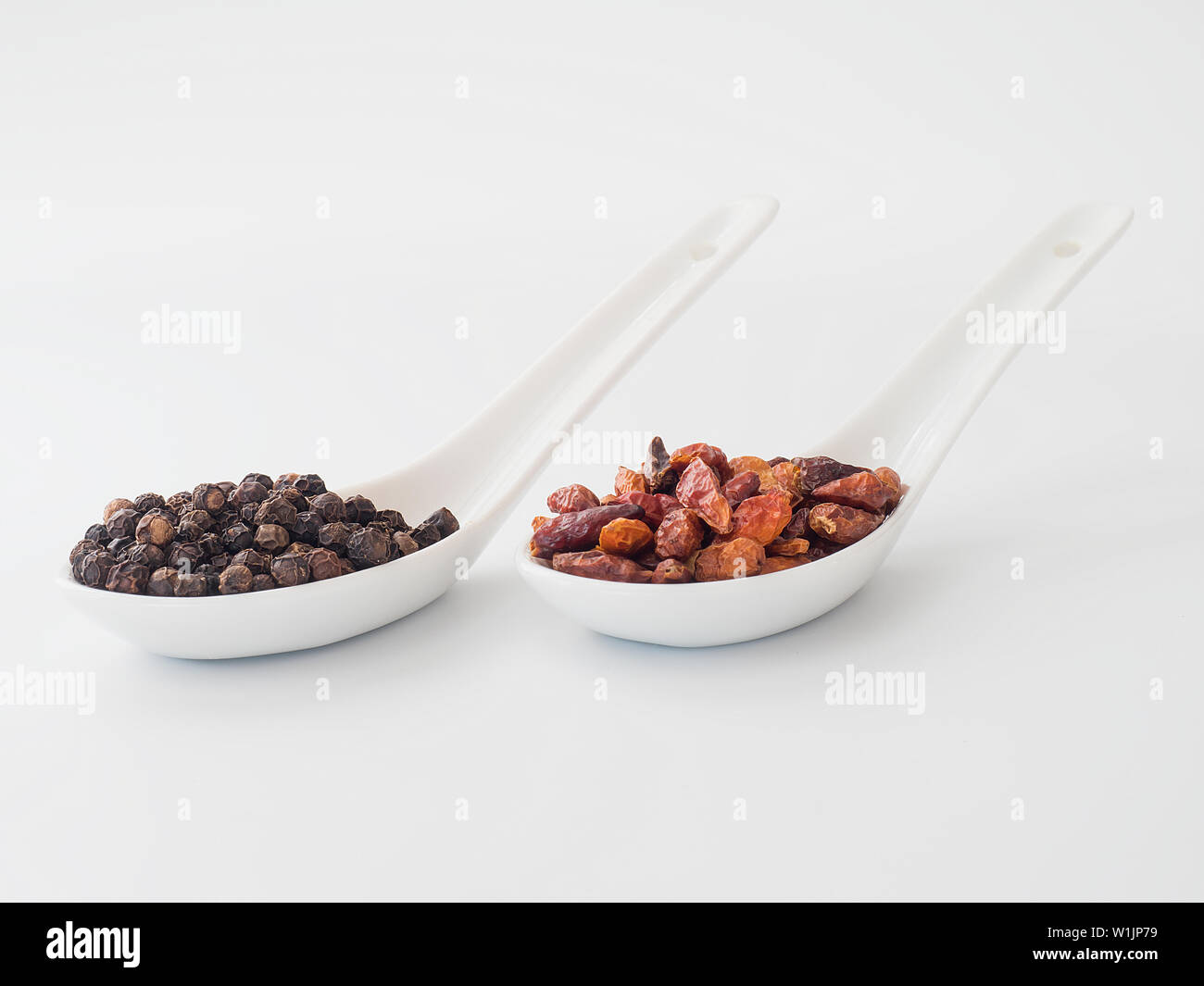 spicy spices in white spoons on white background Stock Photo - Alamy