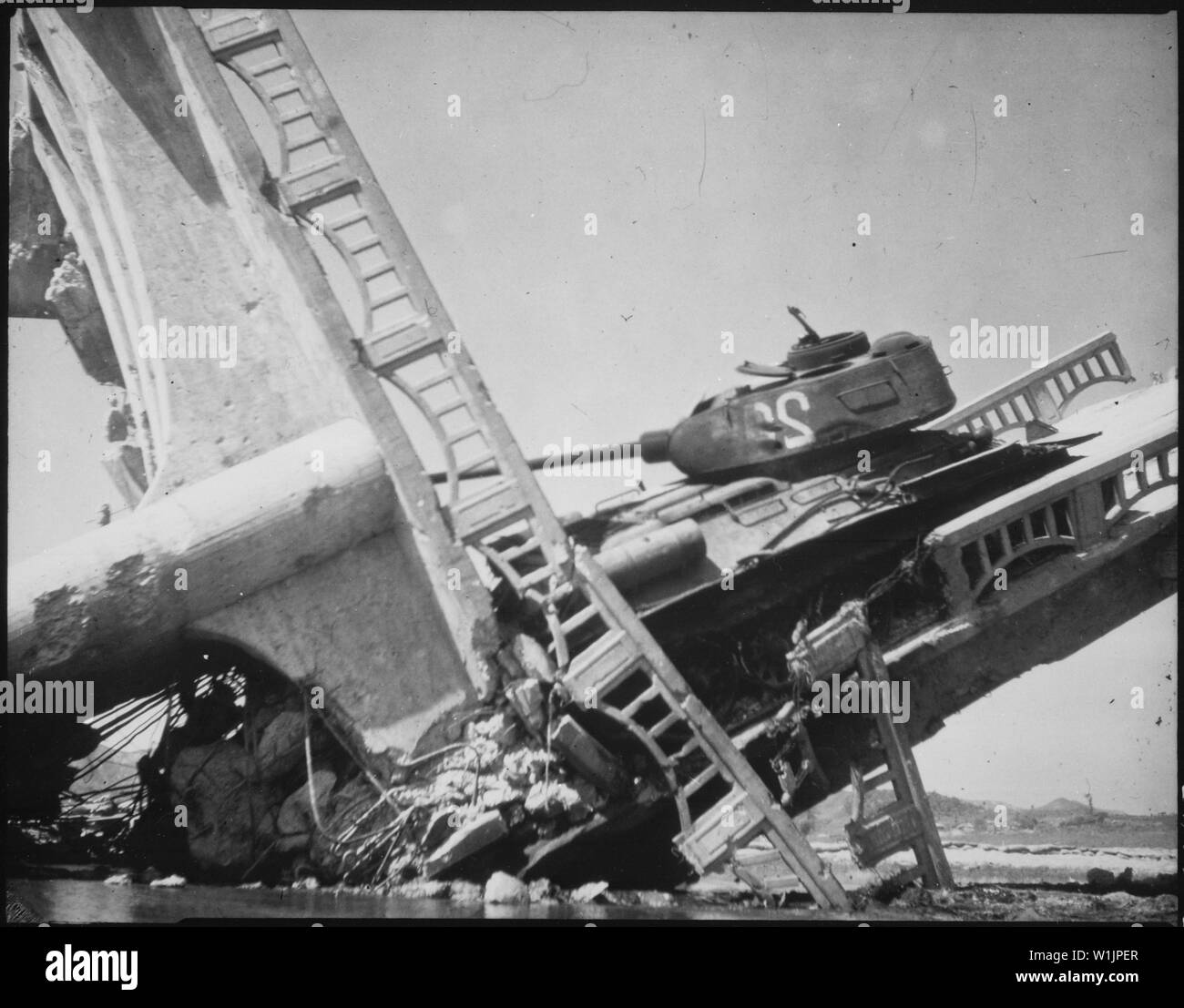 The wreckage of a bridge and North Korean Communist tank south of Suwon ...