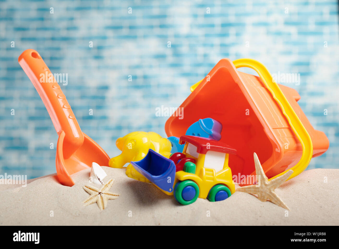 Children's toys on sand Stock Photo - Alamy