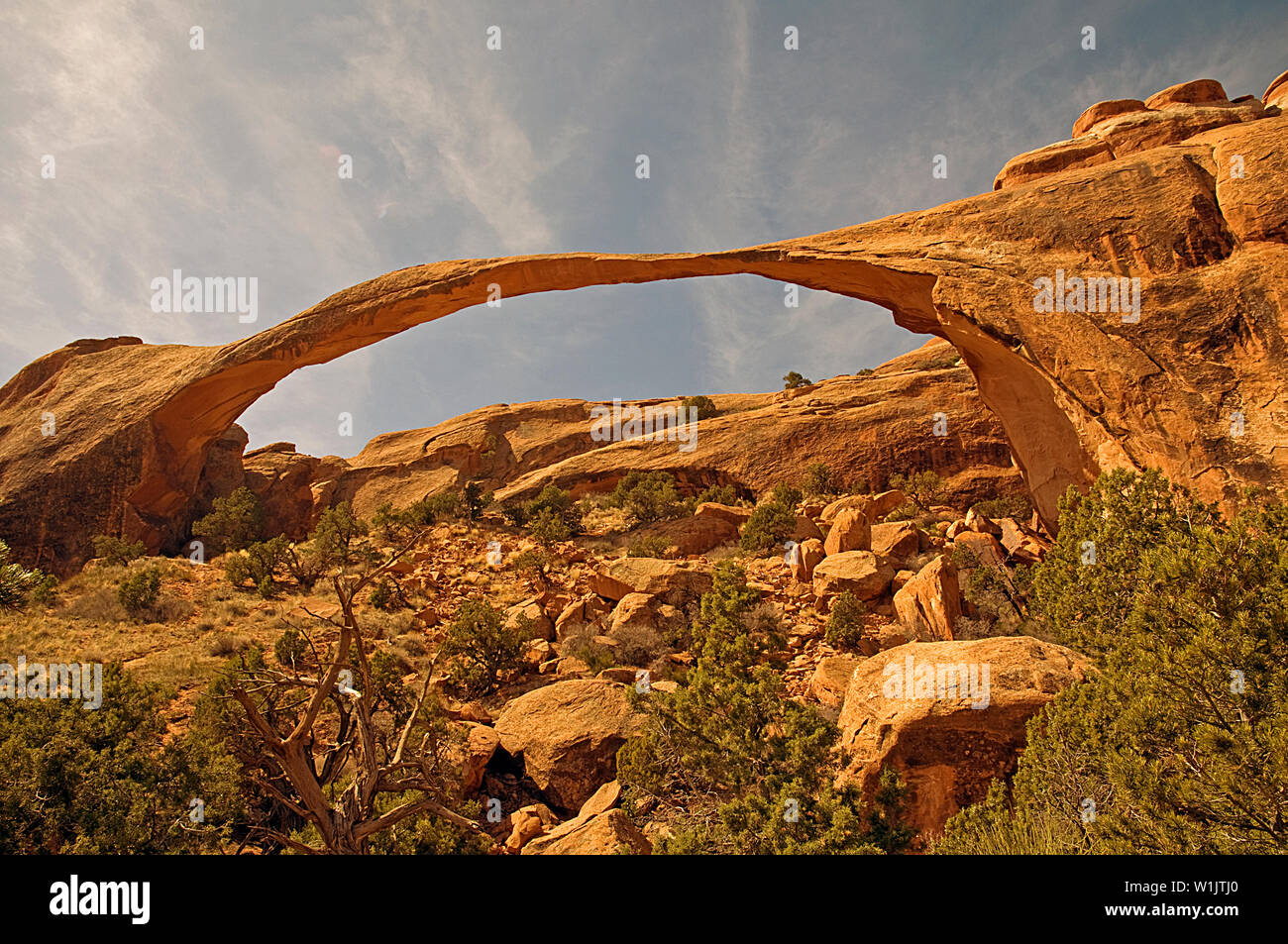 Landscape Arch carves a thin line against the blue spring sky in Arches ...